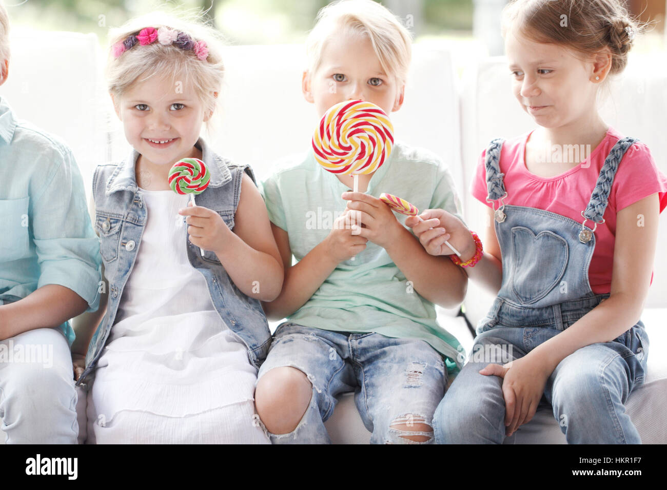 Group of happy smiling children with lollipops outdoors Stock Photo - Alamy