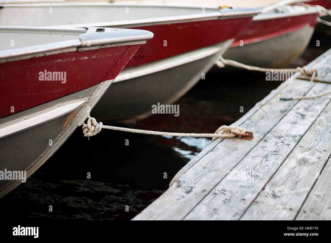 Aluminum fishing boats are tied up to a dock waiting to be used Stock ...