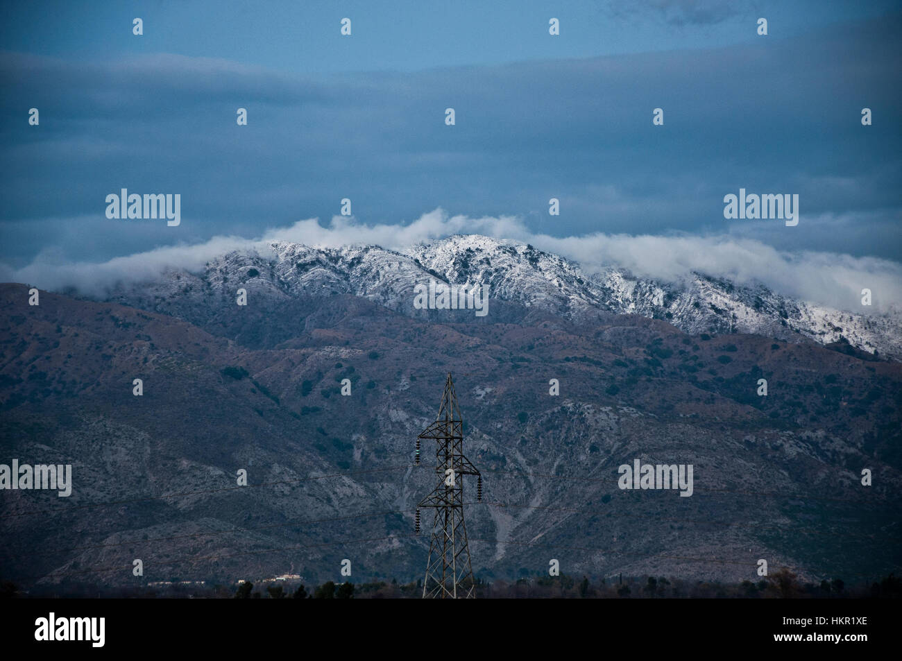 Snowfall on top the cloudy mountain Stock Photo - Alamy