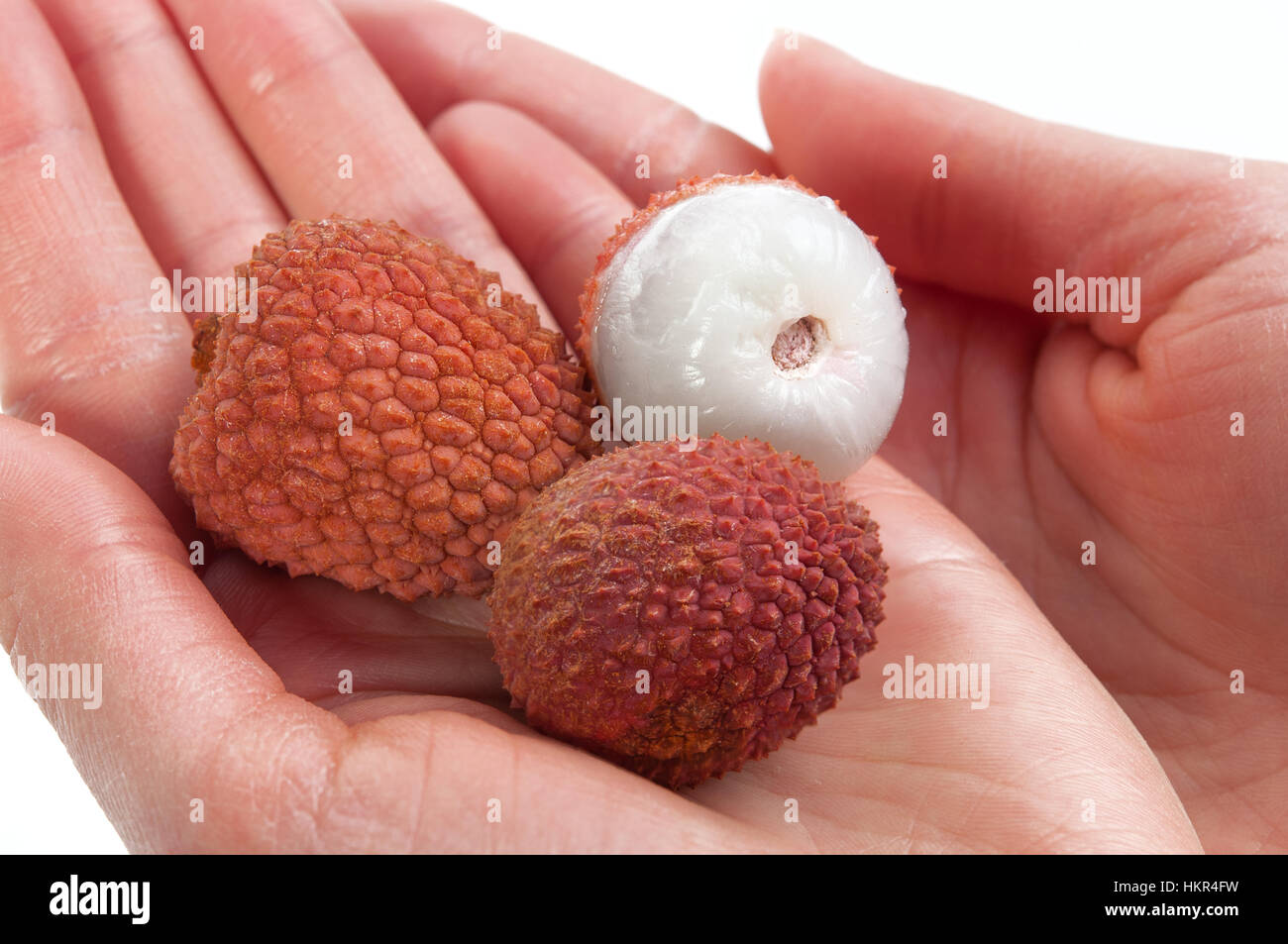 Fresh lychees in the hands on white background Stock Photo - Alamy