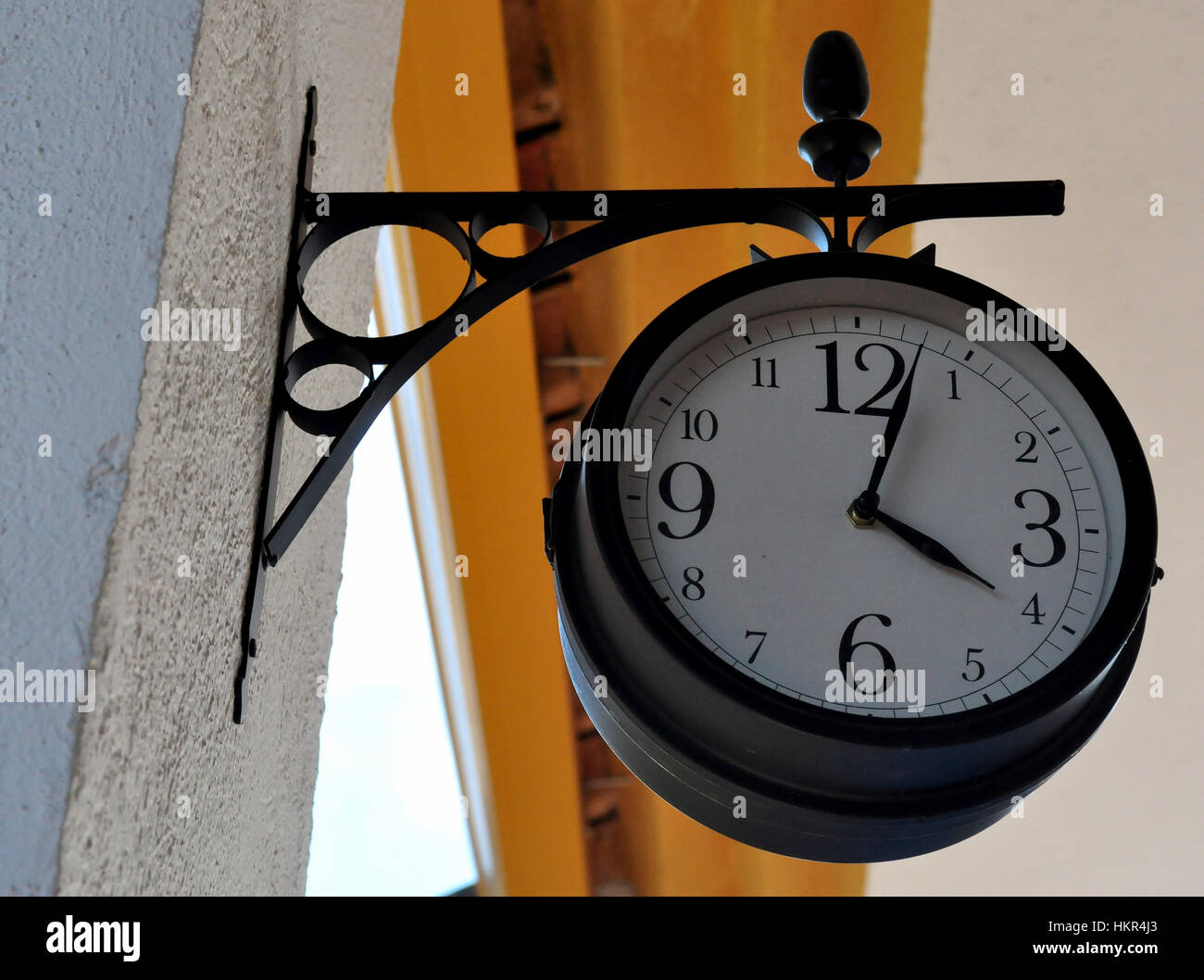 Clock hanging on the wall Stock Photo - Alamy