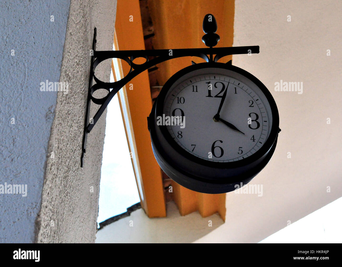 Clock hanging on the wall Stock Photo - Alamy