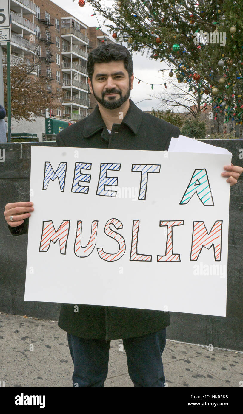 A Muslim American man outdoors on a winter day inviting passers bye to ...