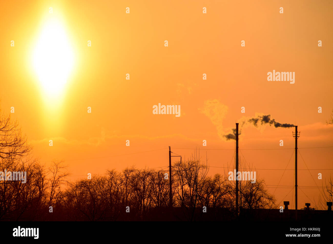 Smoke from the boiler pipes at sunset. Winter landscape Stock Photo - Alamy