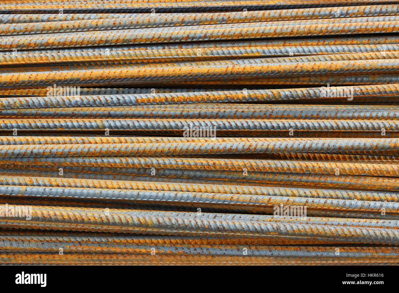 rusty rebar rods lie in a pile near the construction site of the ...