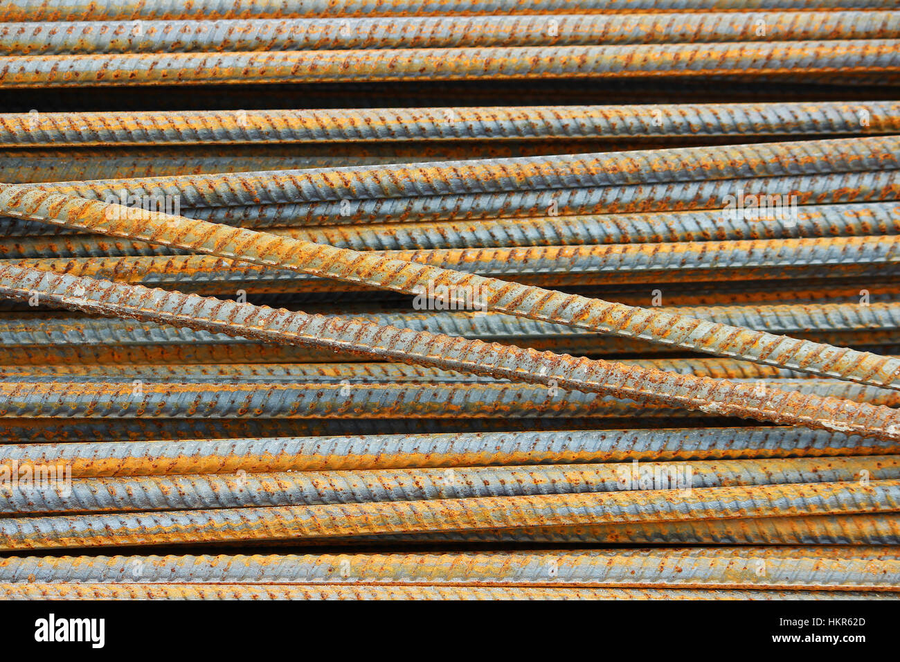 rusty rebar rods lie in a pile near the construction site of the ...