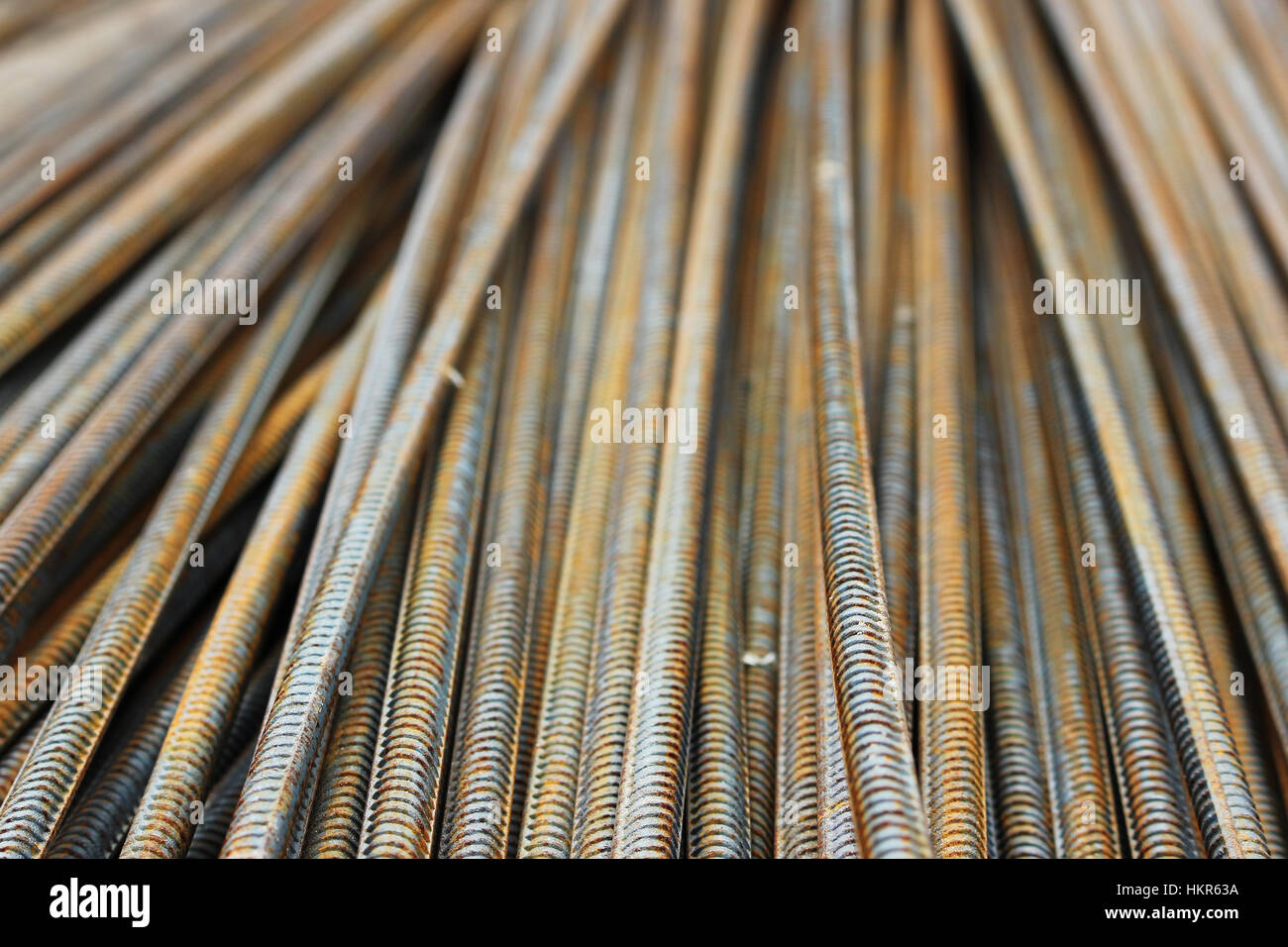 rusty rebar rods lie in a pile near the construction site of the ...