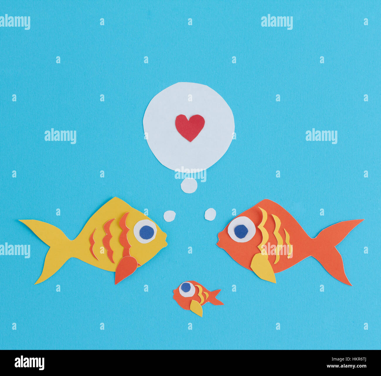 An orange and yellow paper fish couple share feelings of love toward ...