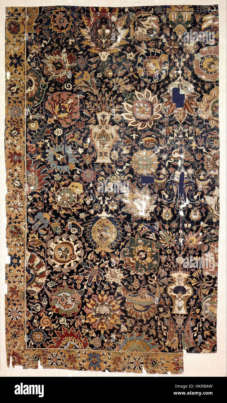 This antique carpet featuring vases is a fine example of decorative ...