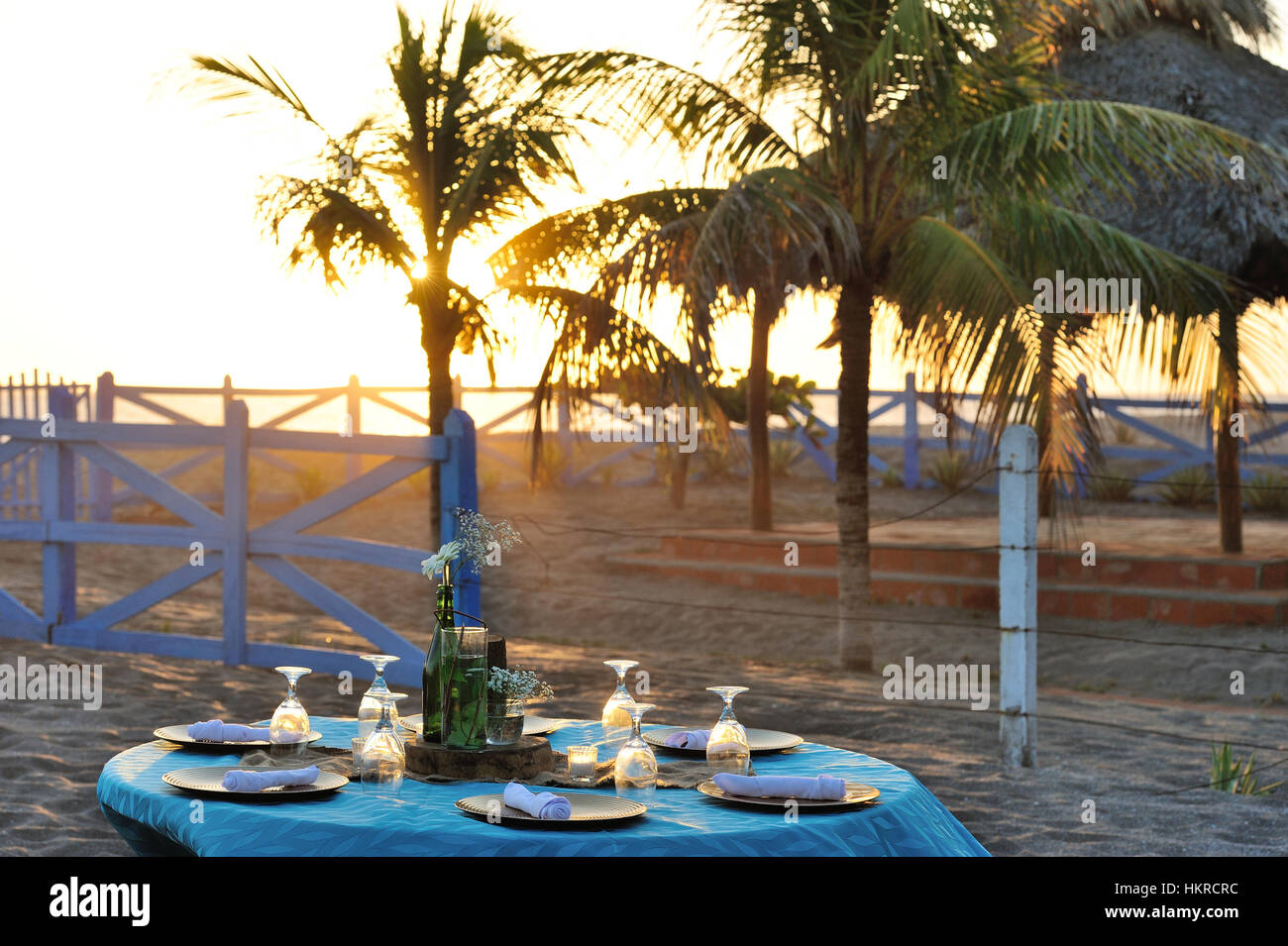 table with plates in romantic sunset light Stock Photo - Alamy