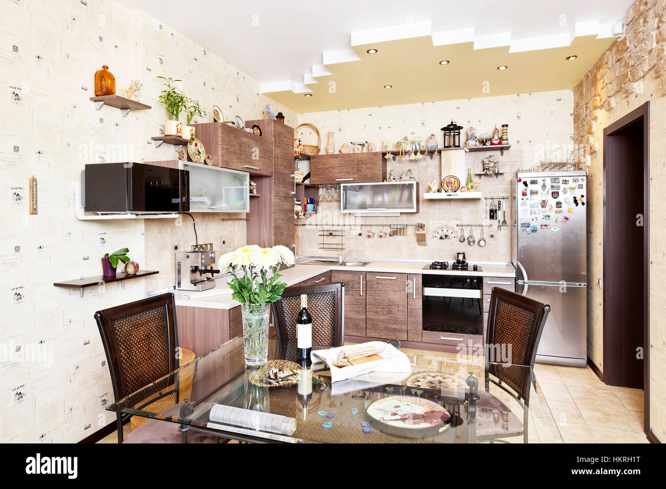Beautiful wooden kitchen with dinner table and decor Stock Photo - Alamy