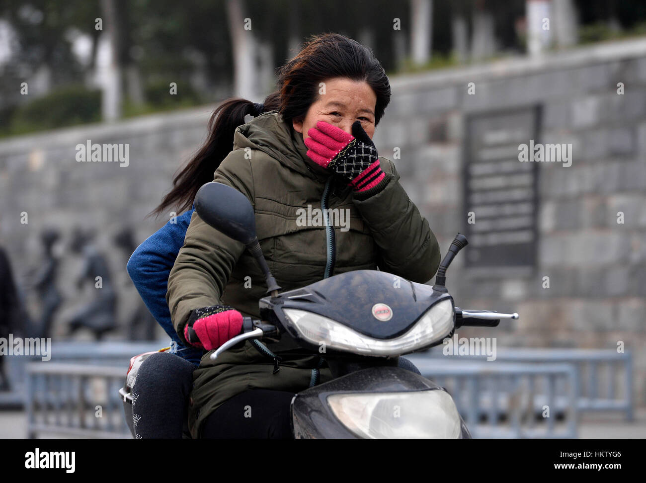 Nanchang, China's Jiangxi Province. 30th Jan, 2017. A woman cycles ...