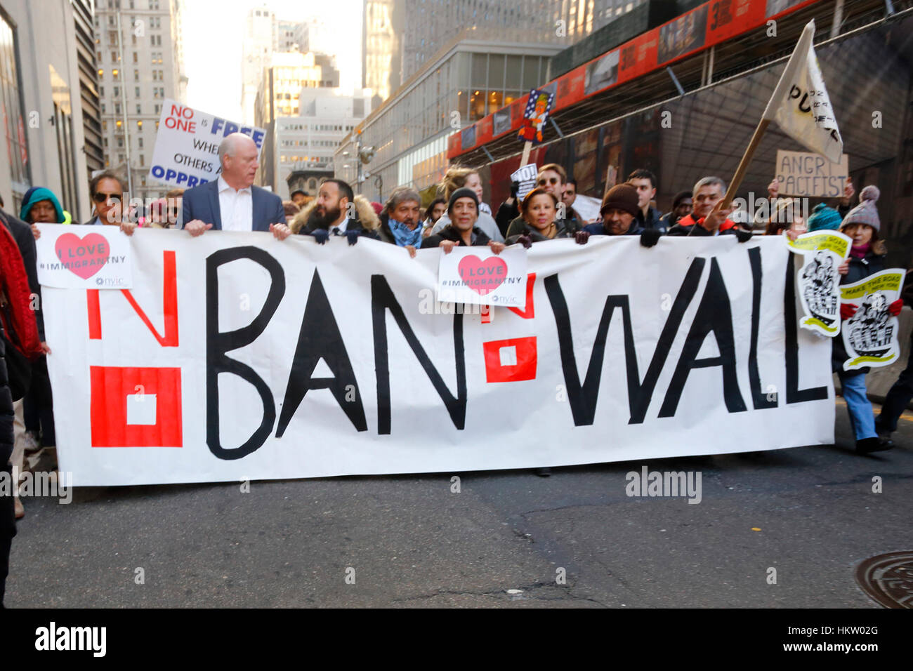 New York, USA. 29th January, 2017. Demonstrators carry a banner "No Ban ...