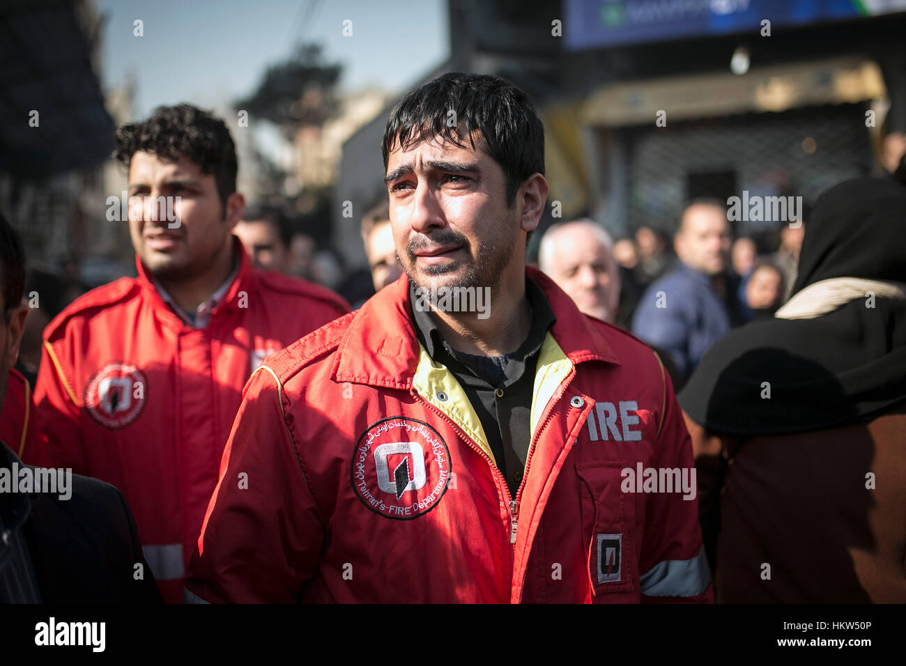 Tehran, Iran. 30th Jan, 2017. An Iranian firefighter cries for their ...