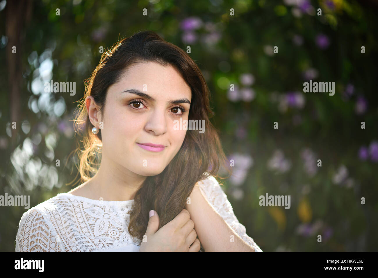 hispanic girl portrait in light og sun in green park Stock Photo - Alamy