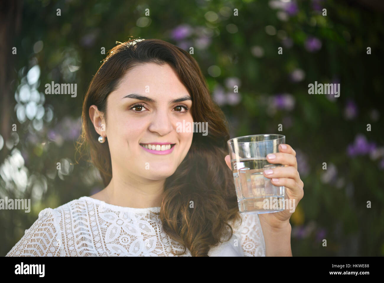 young woman hold glass water in green park background Stock Photo - Alamy young woman hold glass water in green park background Stock Photo - Alamy