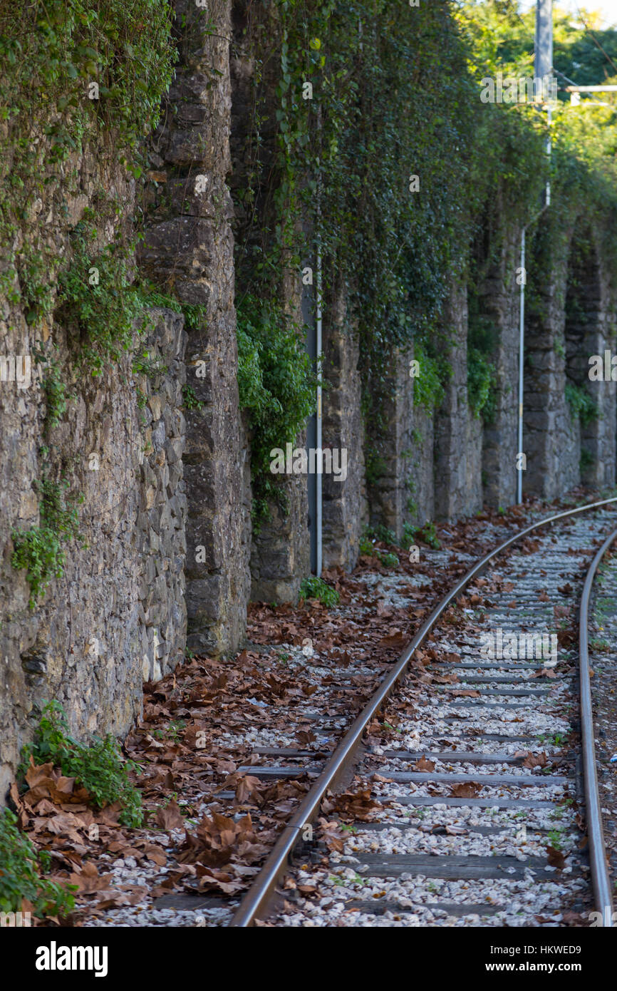 old rails for train near of stone wall Stock Photo - Alamy