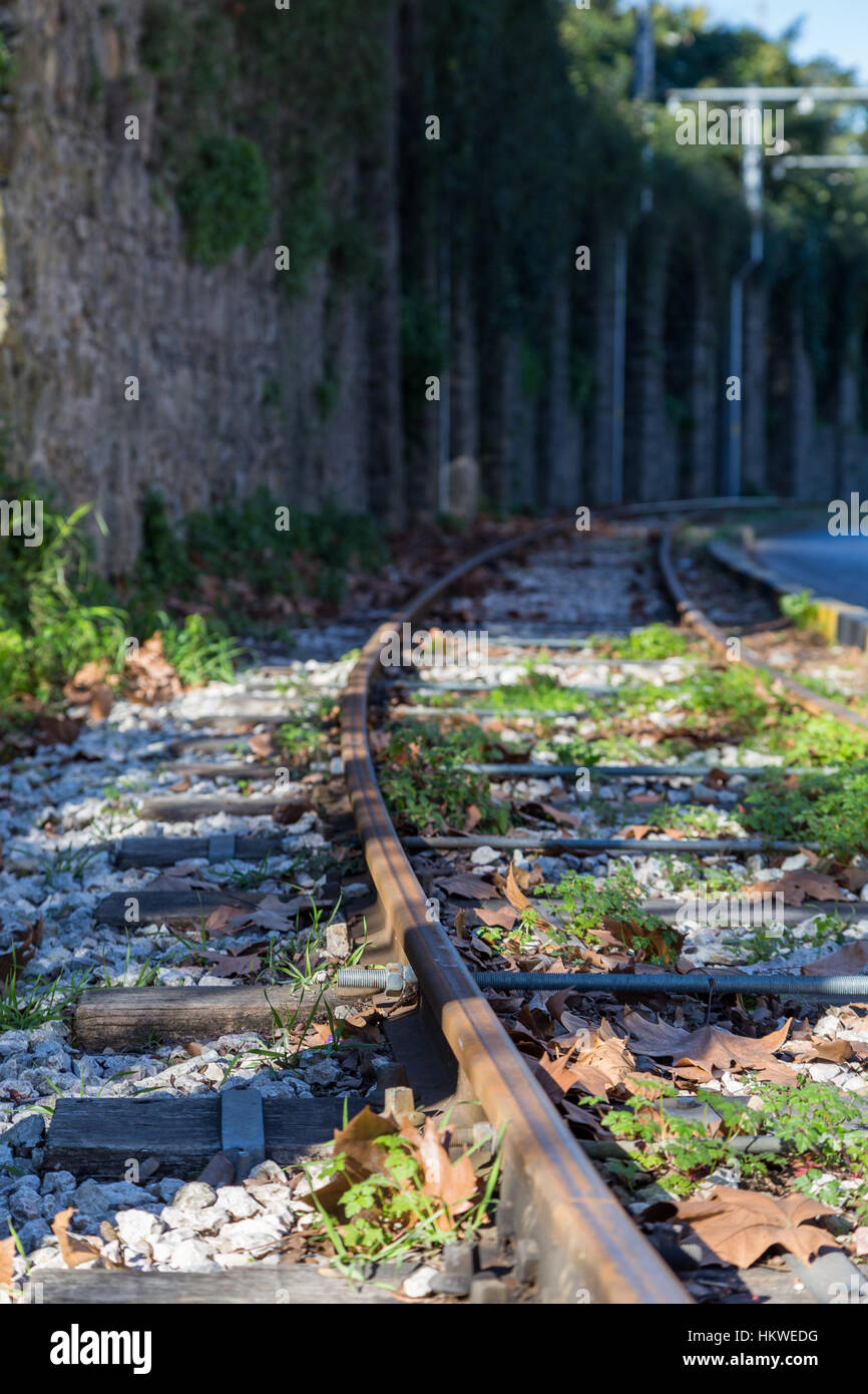 old rails for train near of stone wall Stock Photo - Alamy