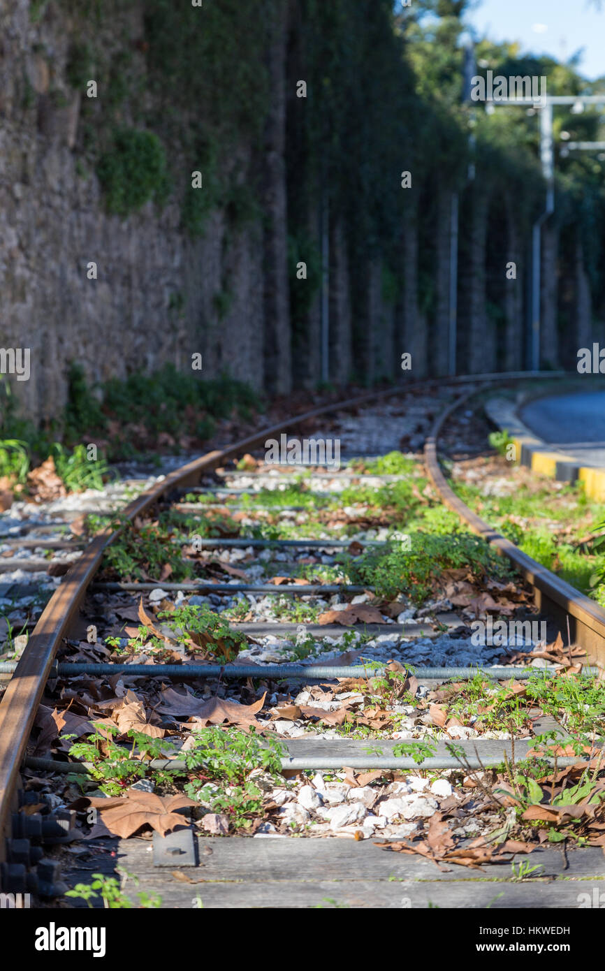 old rails for train near of stone wall Stock Photo - Alamy