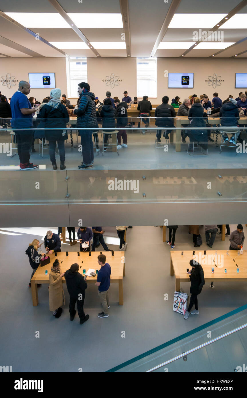 Customers shopping and browsing in the Soho Apple Store in New York ...