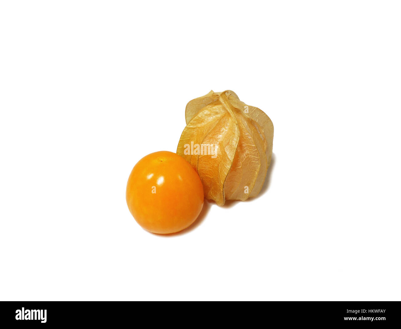 Closed up two ripe vibrant yellow Cape gooseberries one whole one in ...