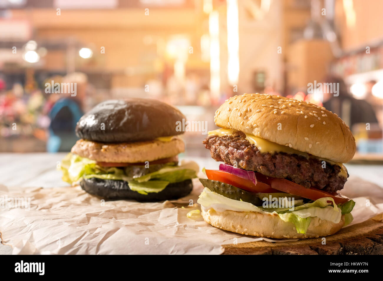Two burgers on paper Stock Photo - Alamy