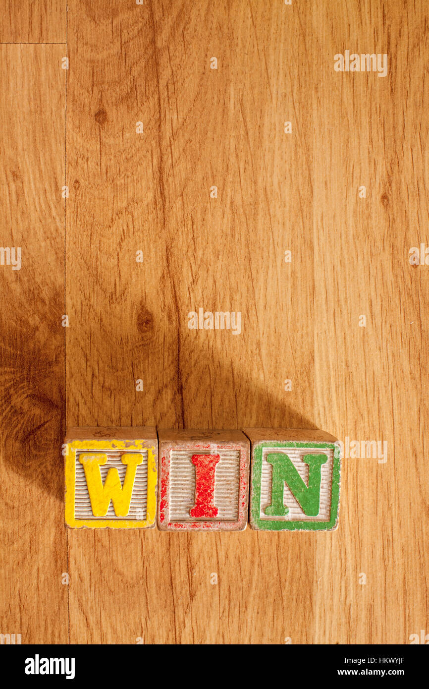 Vintage Wooden Childrens Blocks spell out the word Win Stock Photo - Alamy