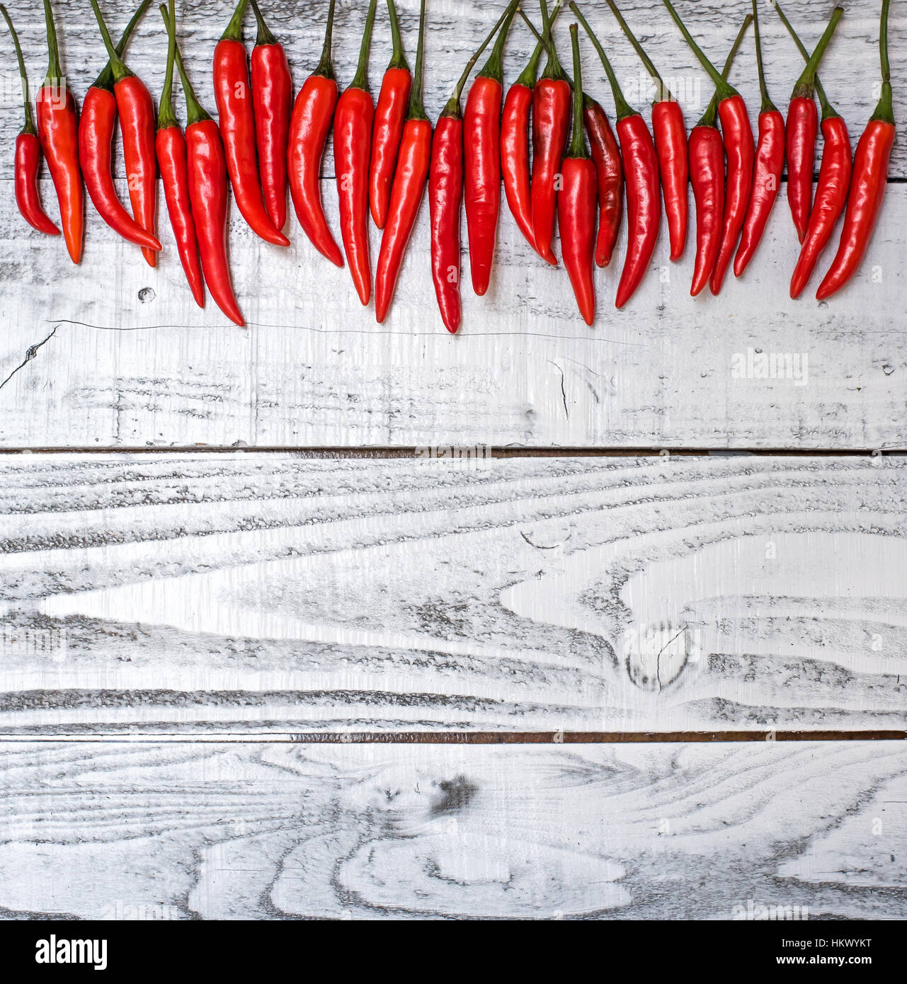 Hot and spicy red chilli on wood table background Stock Photo - Alamy