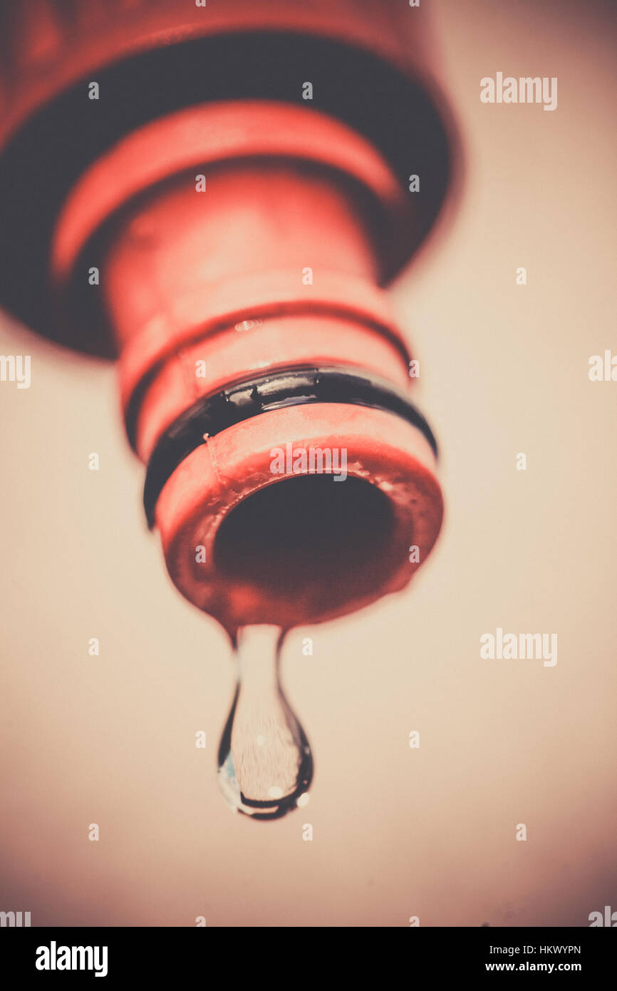 Water dripping from the end of a hose Stock Photo - Alamy