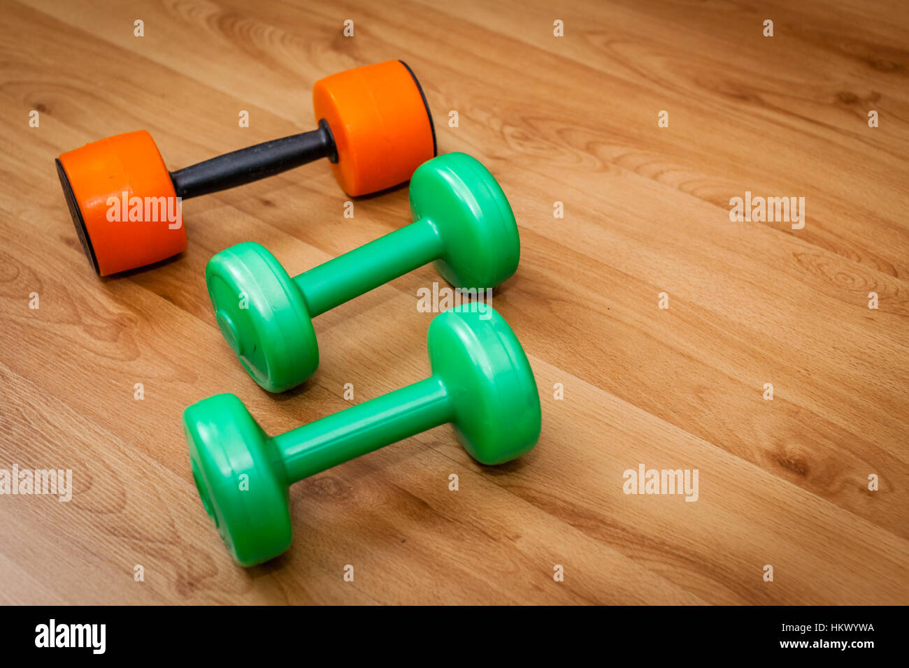 Three light exercise weights on the floor Stock Photo - Alamy