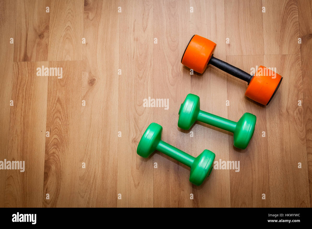 Three light exercise weights on the floor Stock Photo - Alamy