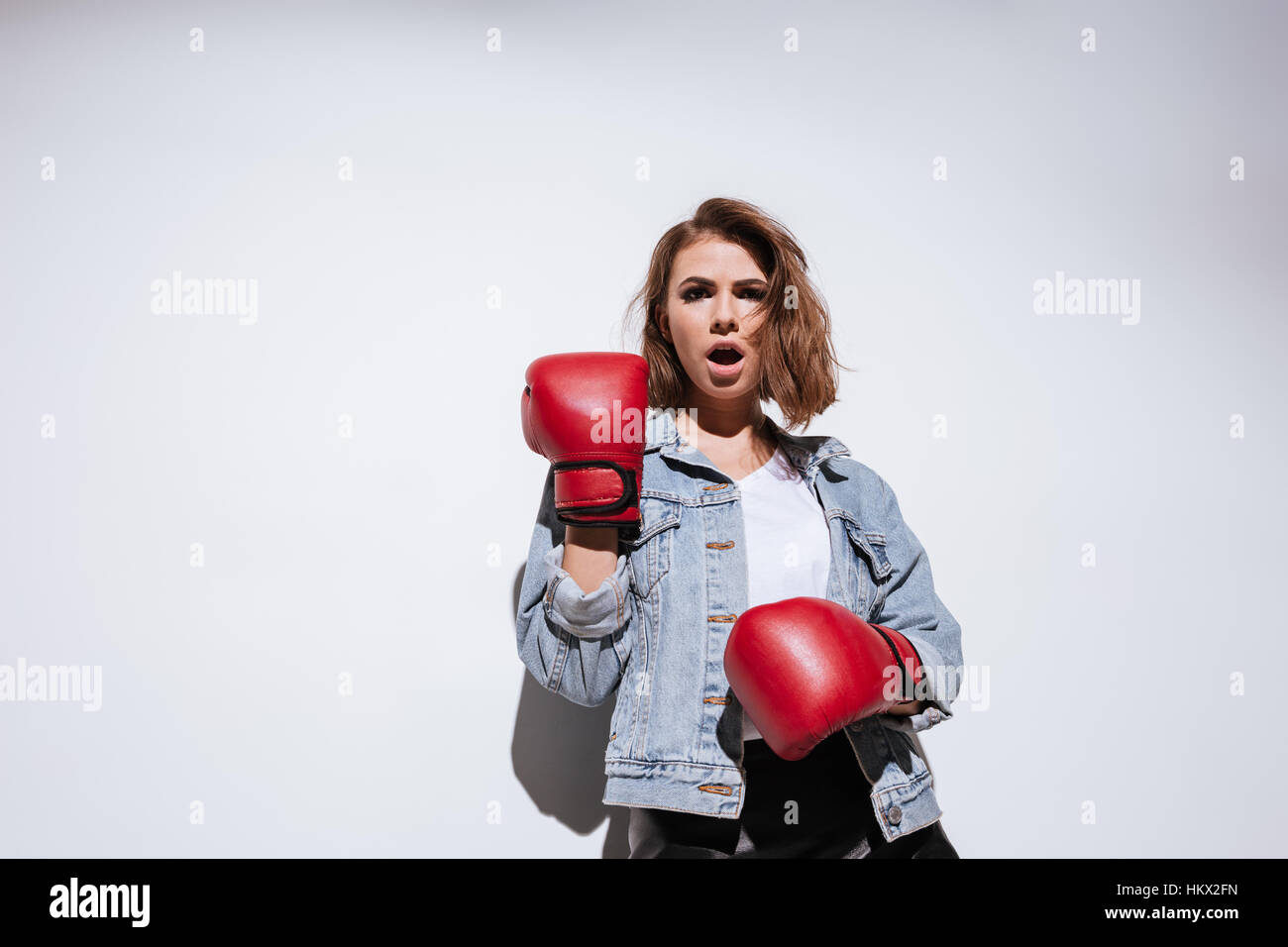 Image of pretty woman boxer dressed in jeans jacket and gloves make ...