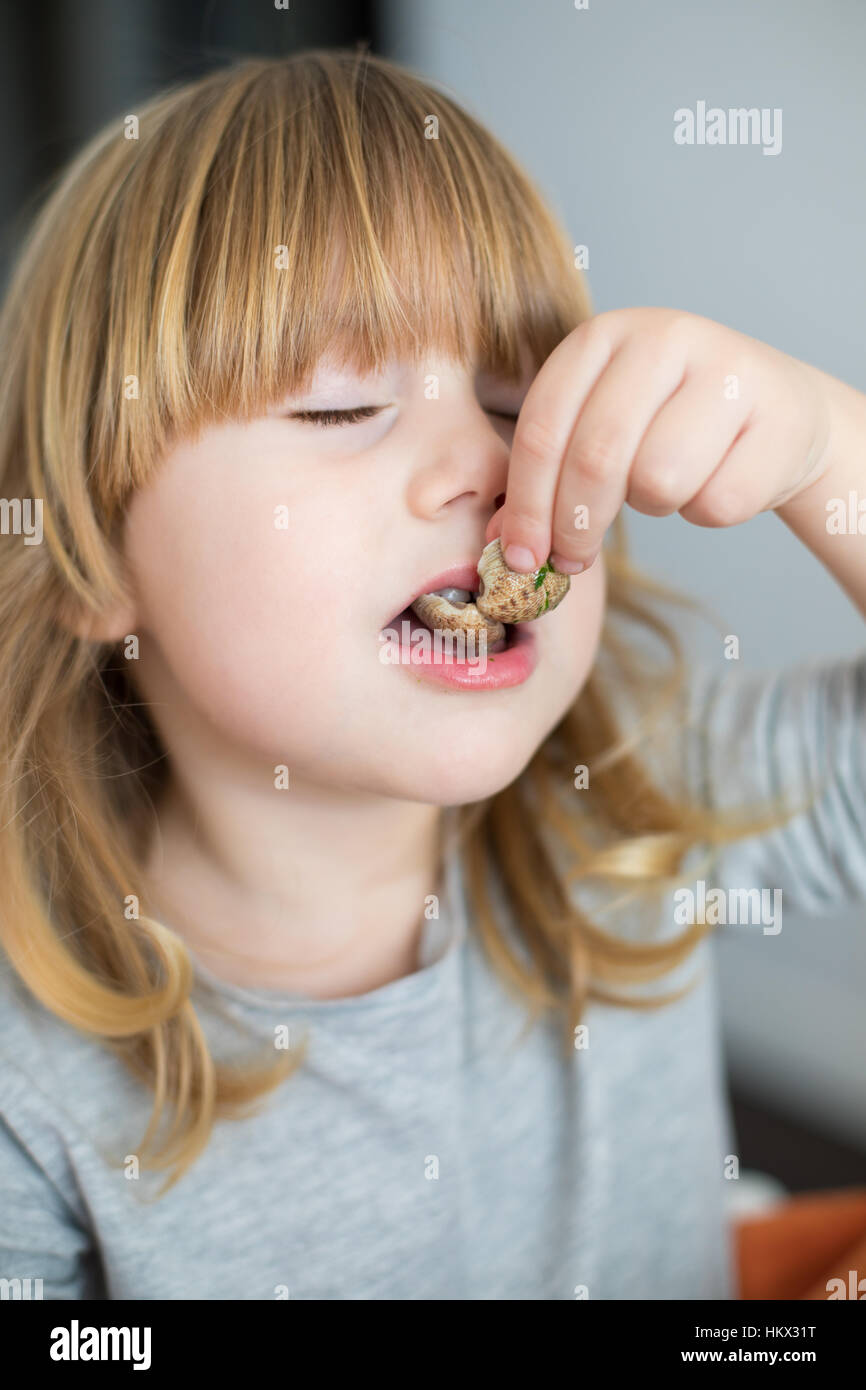 portrait of three years old blonde hungry child face, with grey shirt ...