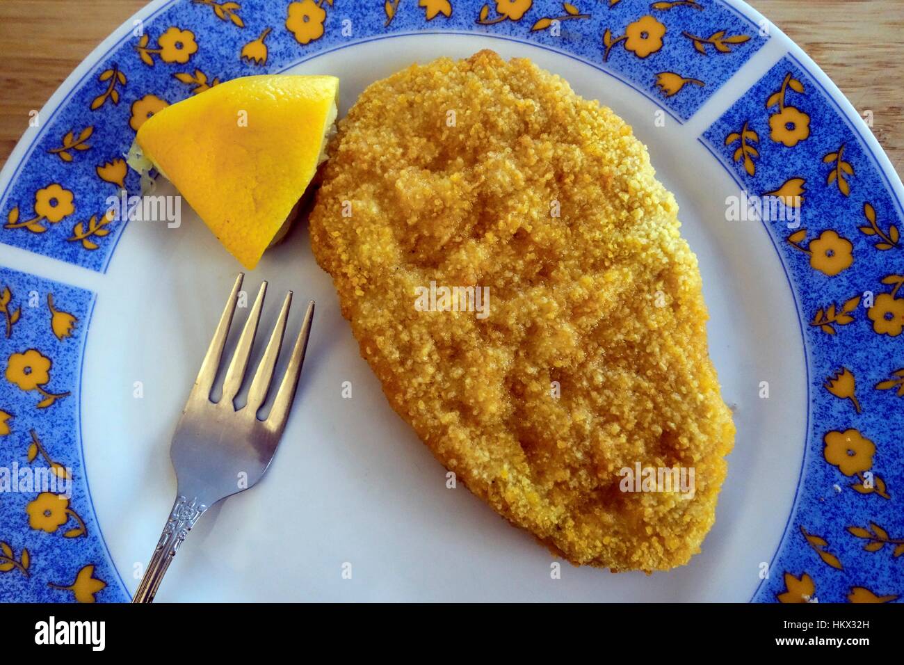 Fried chicken schnitzel with lemon Stock Photo - Alamy
