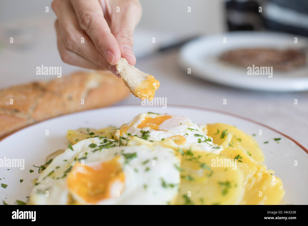 Woman dipping bread into dip hi-res stock photography and images - Alamy