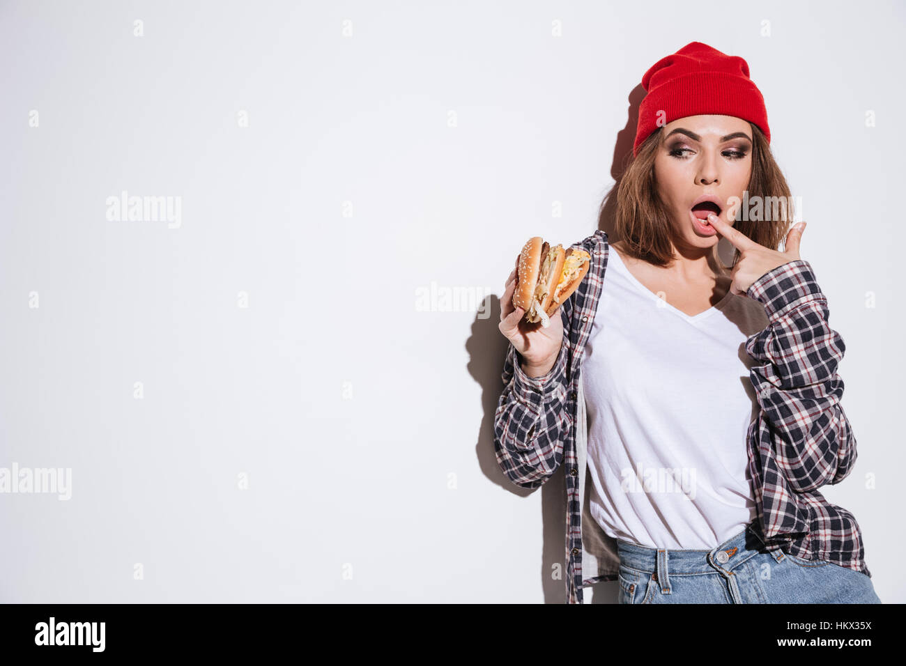 Picture of hungry lady dressed in shirt in a cage print wearing hat ...