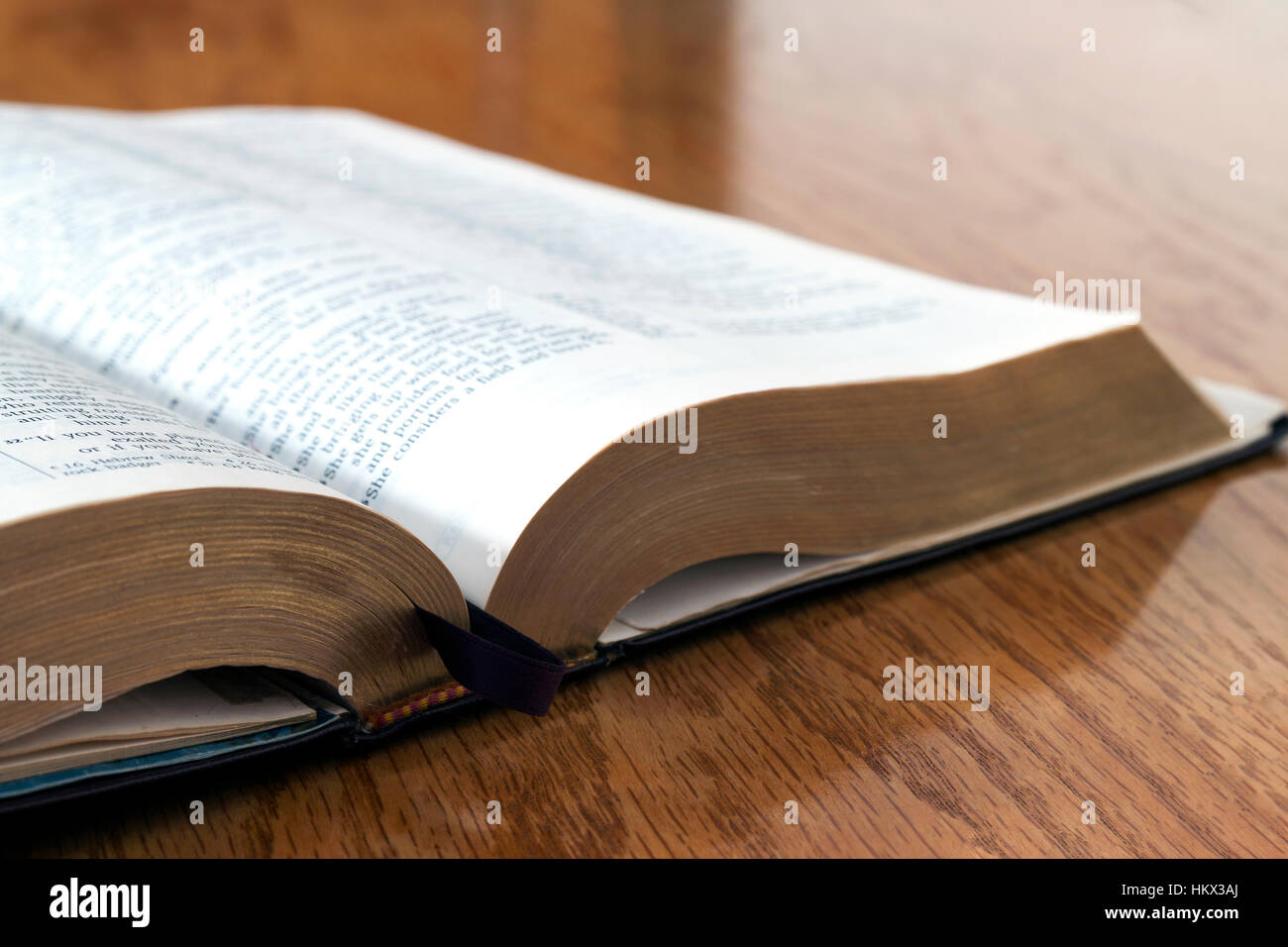 Open book Holy Bible on yellow wooden background Stock Photo - Alamy