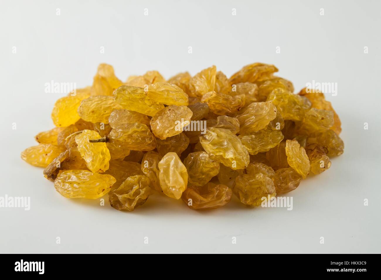 Pile of yellow raisins isolated on white background Stock Photo - Alamy