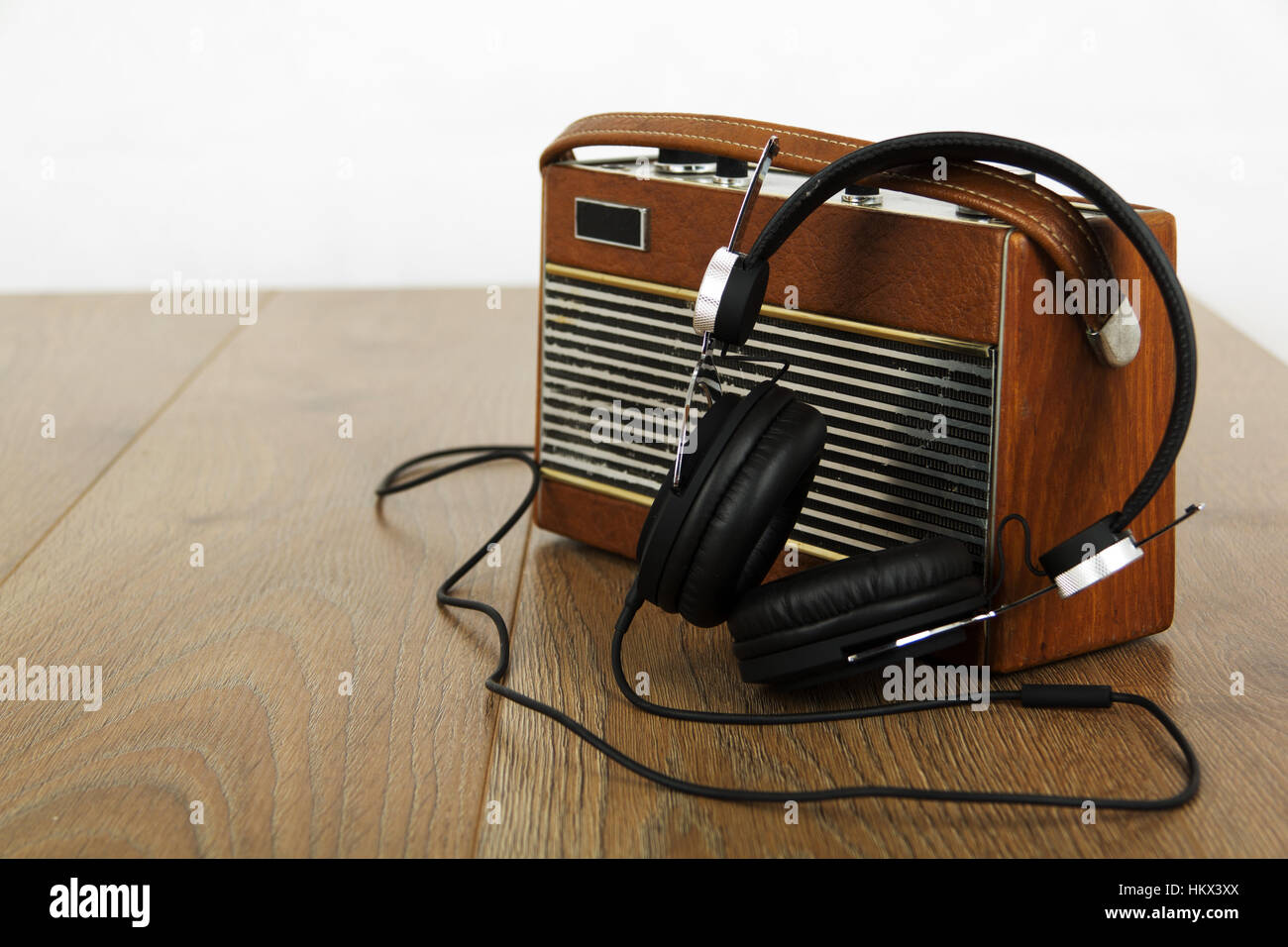 Headphones and old vintage radio on wooden surface Stock Photo - Alamy
