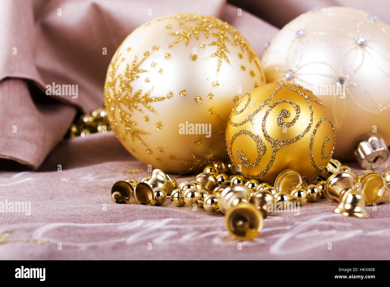 Festive gold Christmas decorations on a fabric background Stock Photo ...
