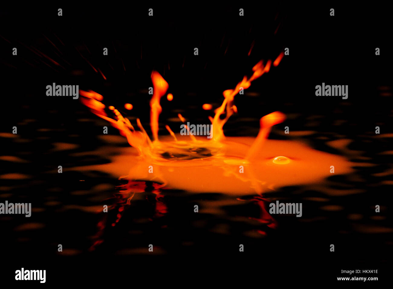 Colorful paint drop splashing on black a background Stock Photo - Alamy