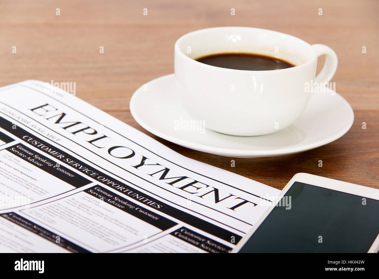 Searching for a new job or employment in a newspaper Stock Photo - Alamy