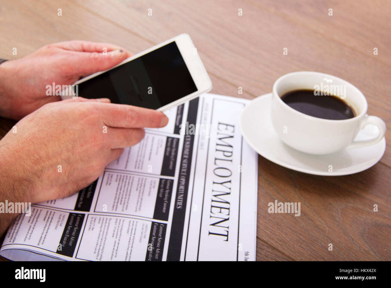 Searching for a new job or employment in a newspaper Stock Photo - Alamy