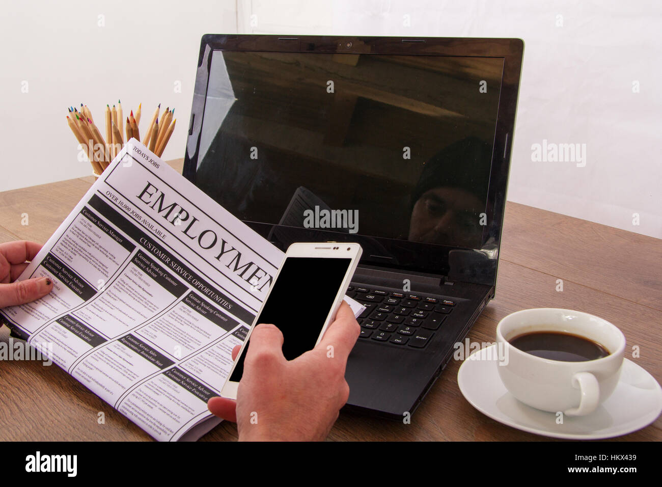 Searching for a new job or employment in a newspaper Stock Photo - Alamy