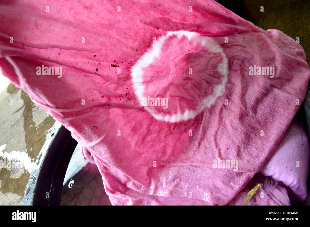 Thai women washing and clean clothes after tie batik dyeing red and ...
