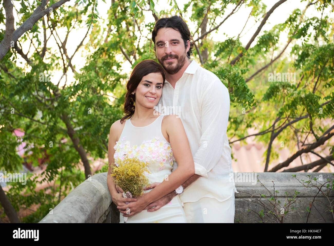 happy married couple stand on balcony in sunset light Stock Photo - Alamy
