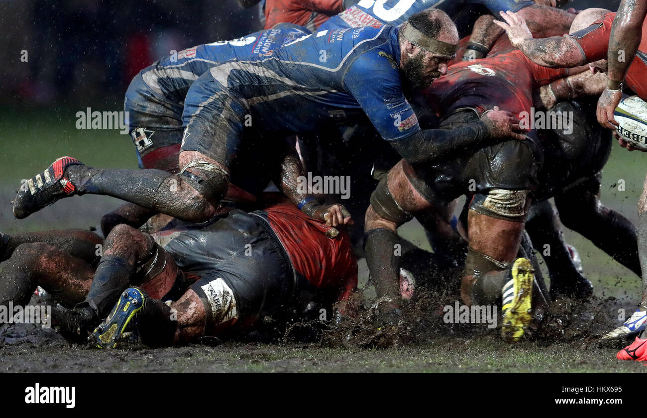 Play drives through the mud during the Anglo-Welsh Cup match at Rodney ...