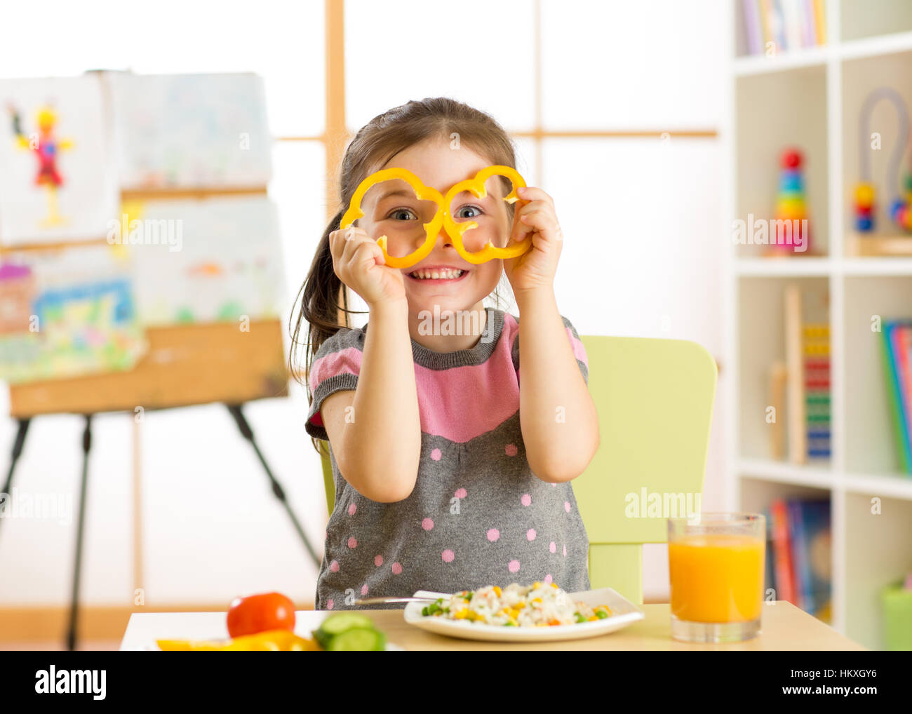 Child girl having fun with food vegetables at nursery room Stock Photo ...