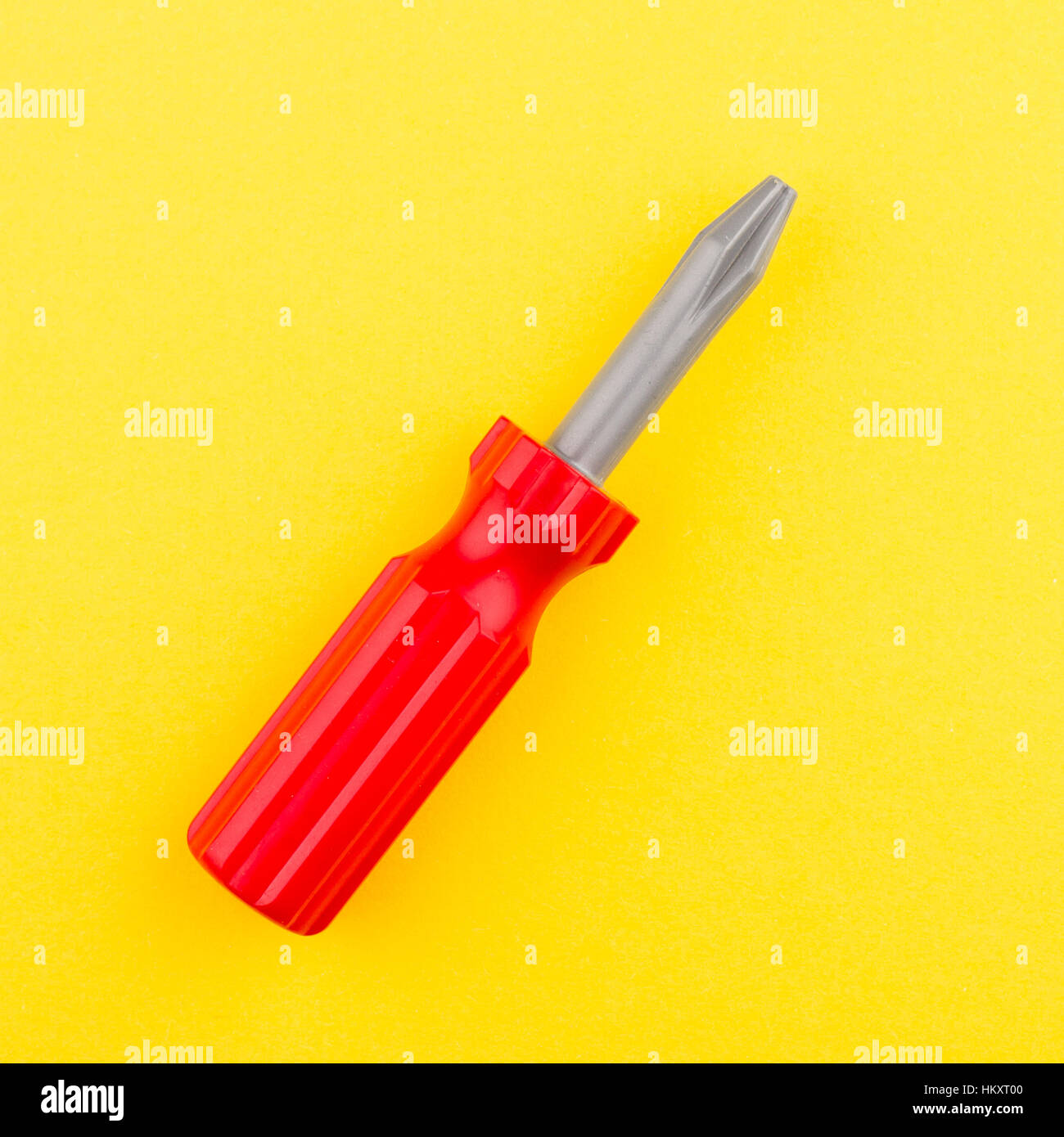 top view of red plastic toy screwdriver on yellow background Stock ...