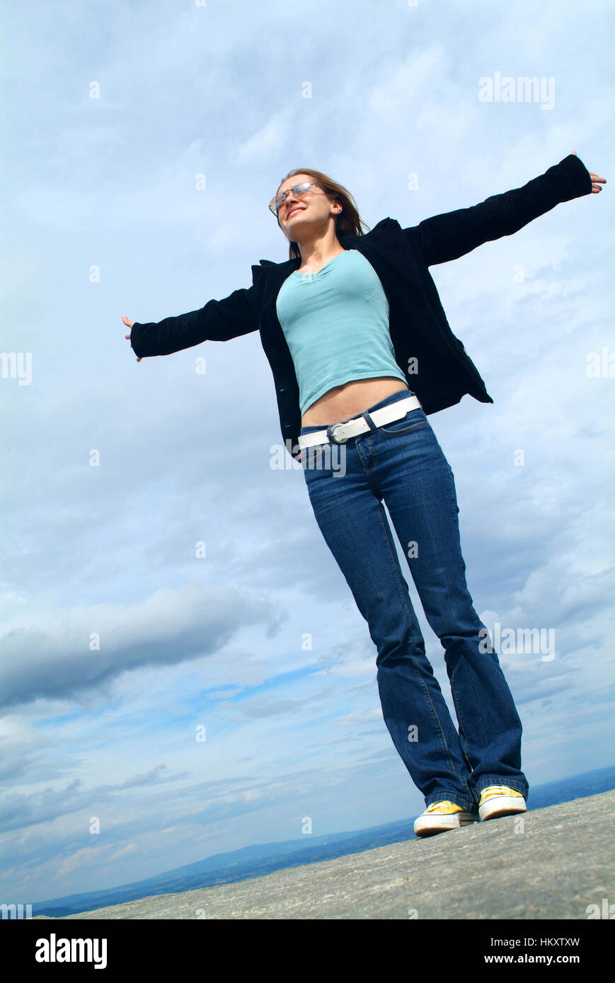Woman standing on a rock, symbolic for freedom Stock Photo - Alamy
